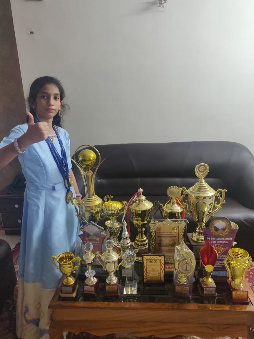 Amrutha proudly displaying her impressive collection of chess trophies ...