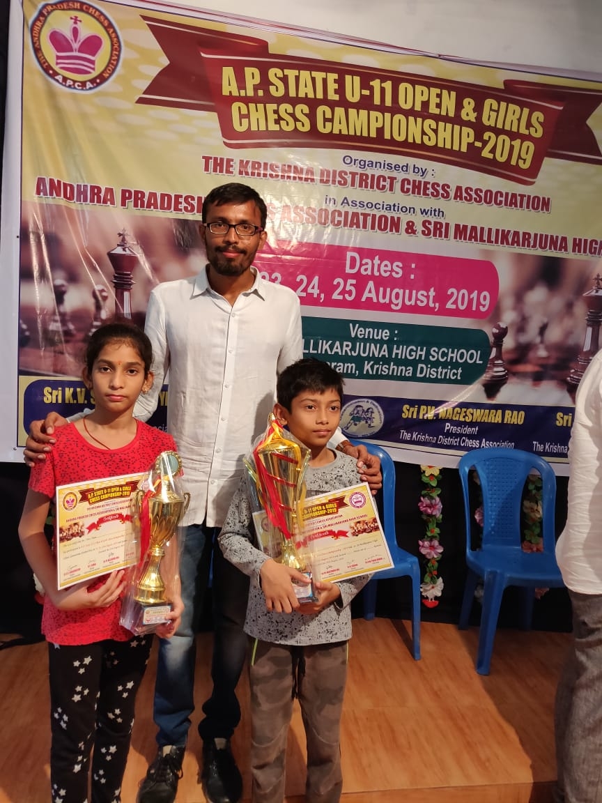 Md Imran and Amrutha holding championship trophies at A.P. State U-11 ...